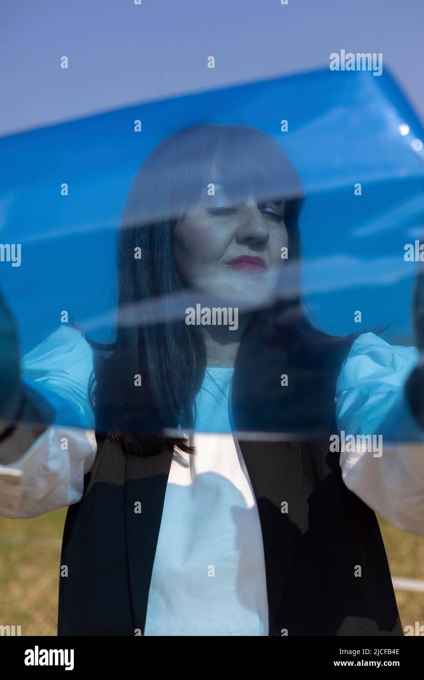 Woman with blue color foil Stock Photo - Alamy