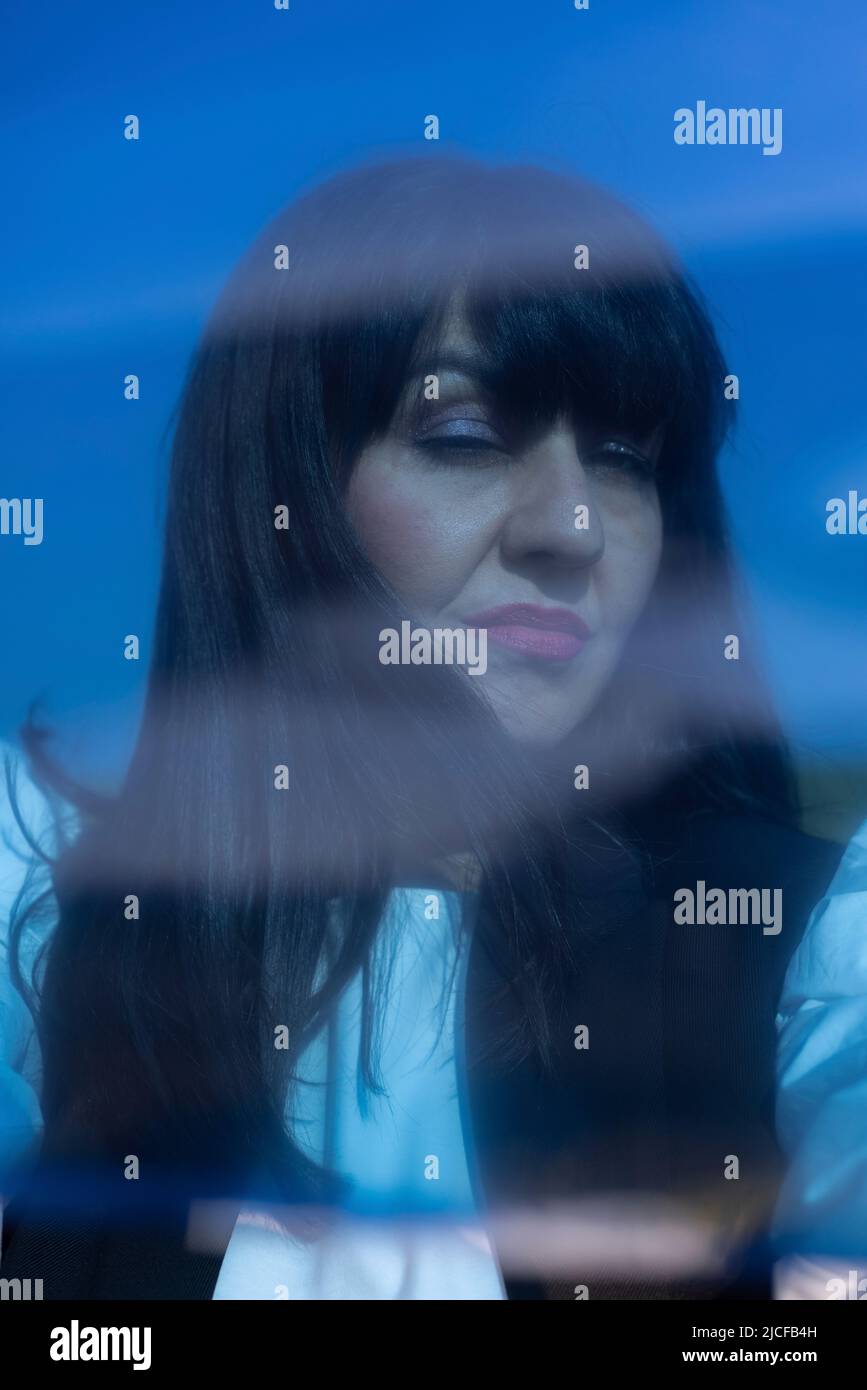 Close up of woman behind blue color film Stock Photo - Alamy