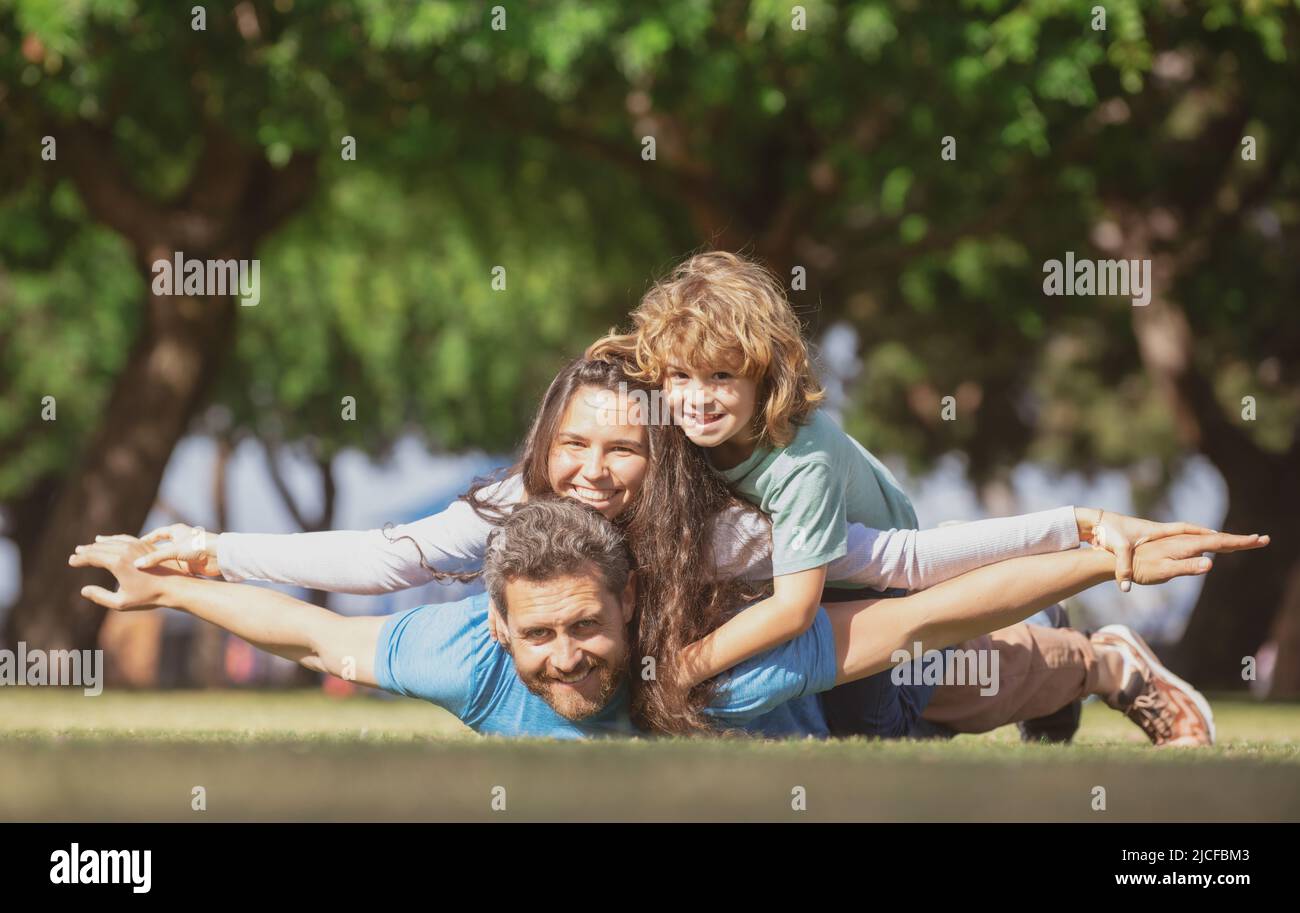 Mother father and child son hugging and embracing outdoors at summer ...
