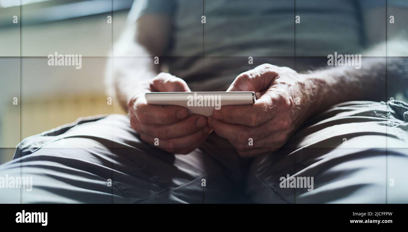 Man sitting using his smartphone, geometric pattern Stock Photo - Alamy
