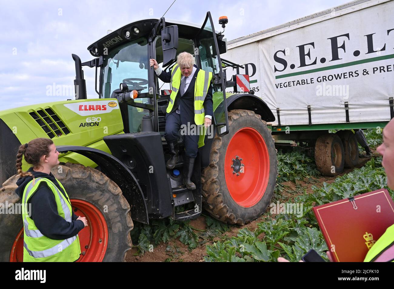 Prime Minister Boris Johnson steps out of the cab of a tractor during a ...