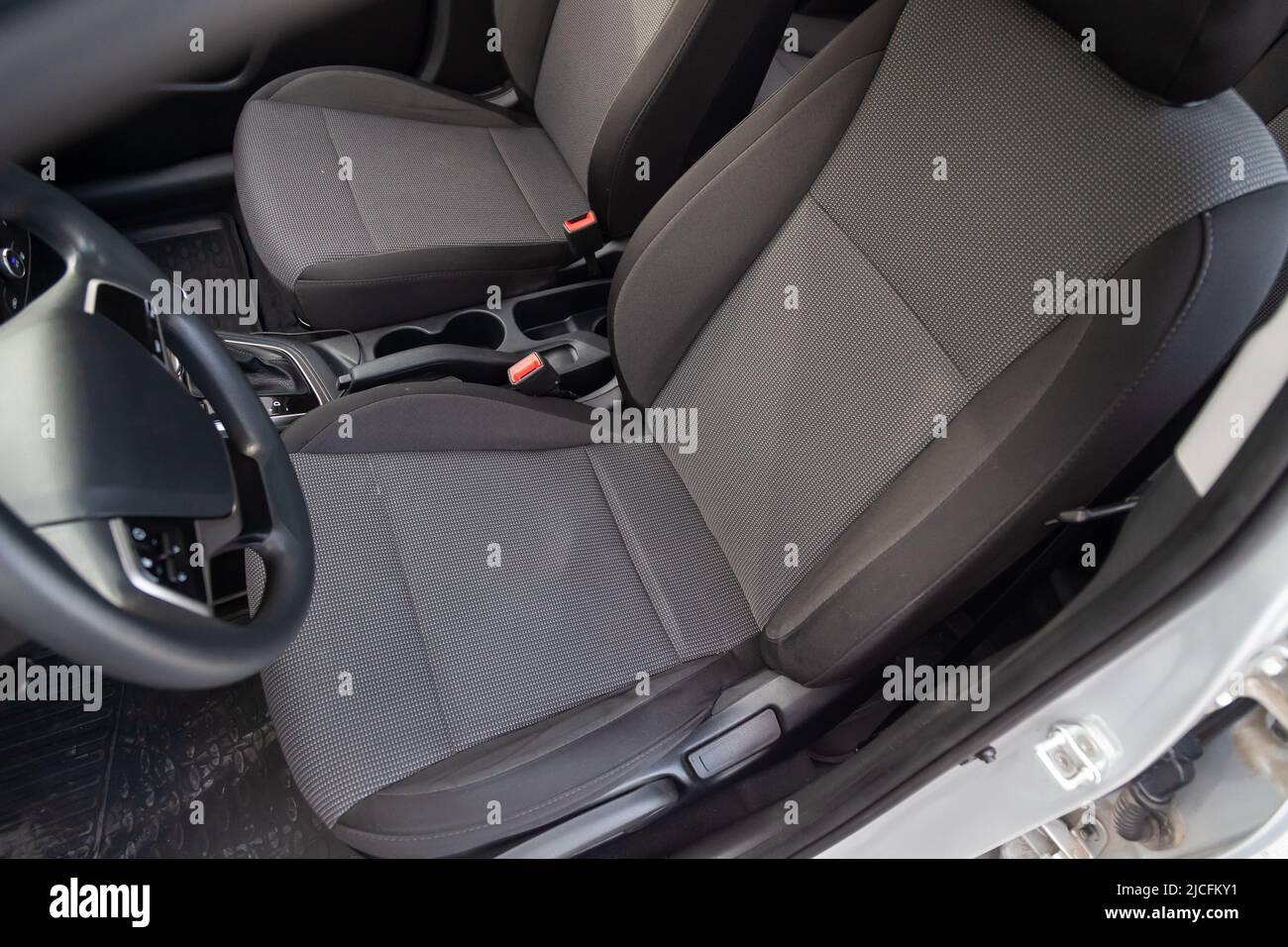 Comfortable front seats inside the car: the driver and passenger, tied ...