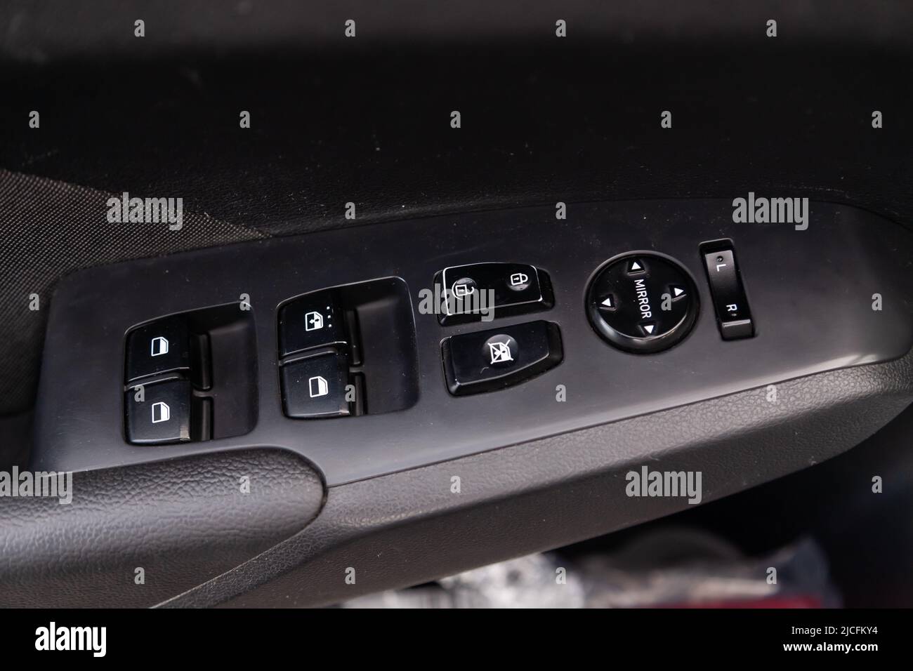 Close-up of the side door buttons: window adjustment buttons, door lock ...
