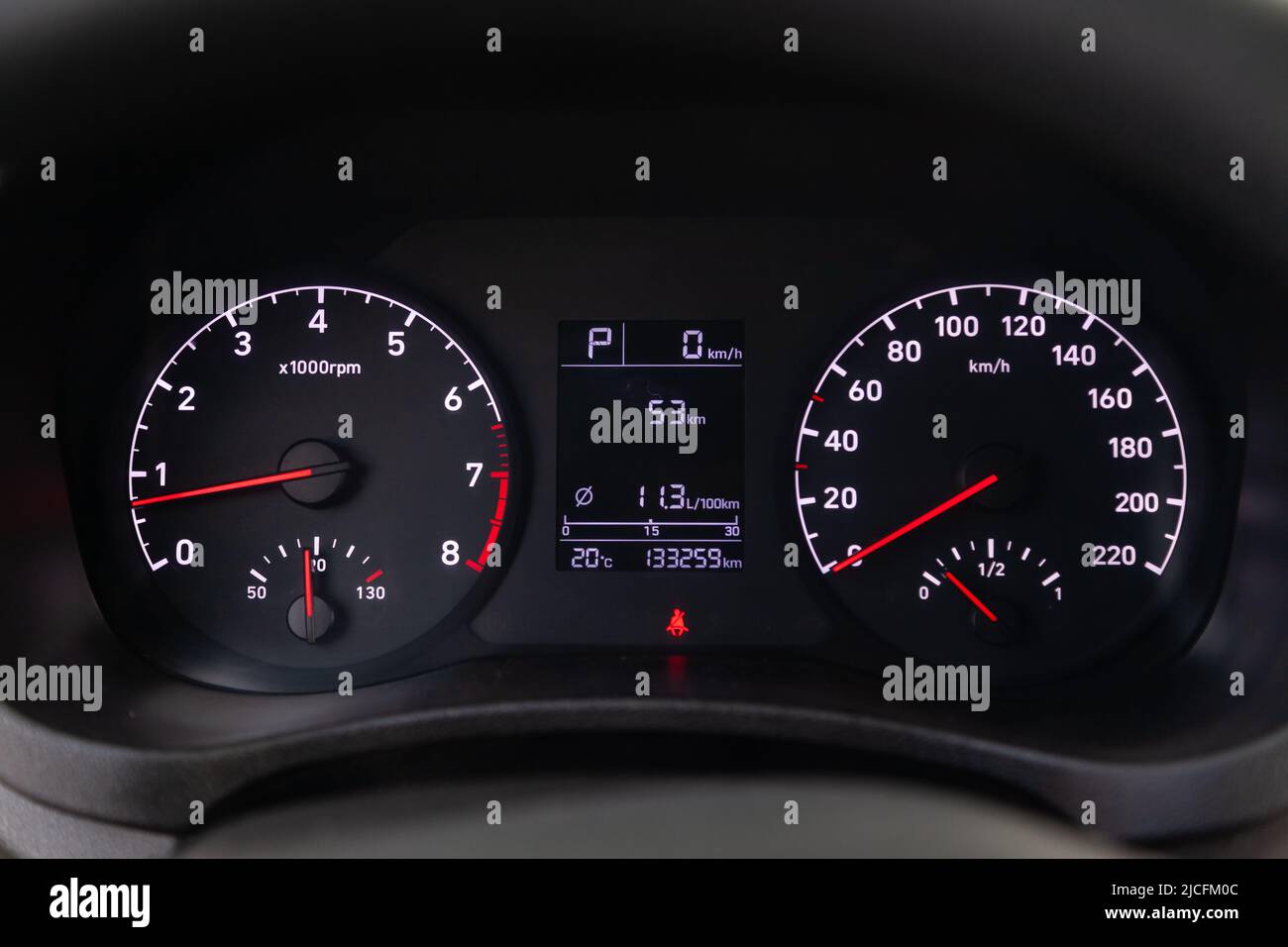 Modern car illuminated dashboard closeup. White arrows on Speedometer ...