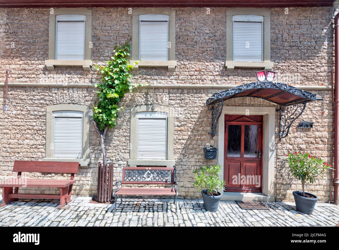 House facade, oleander, wooden bench, front door, window, spring ...