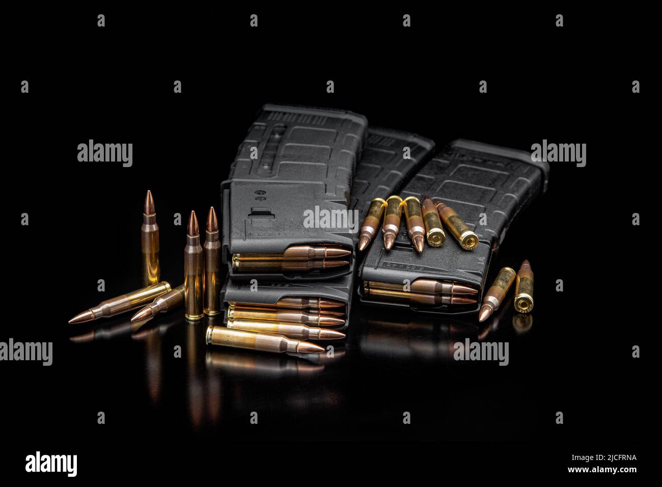 Bullet isolated on black background with reflexion. Rifle bullets close ...
