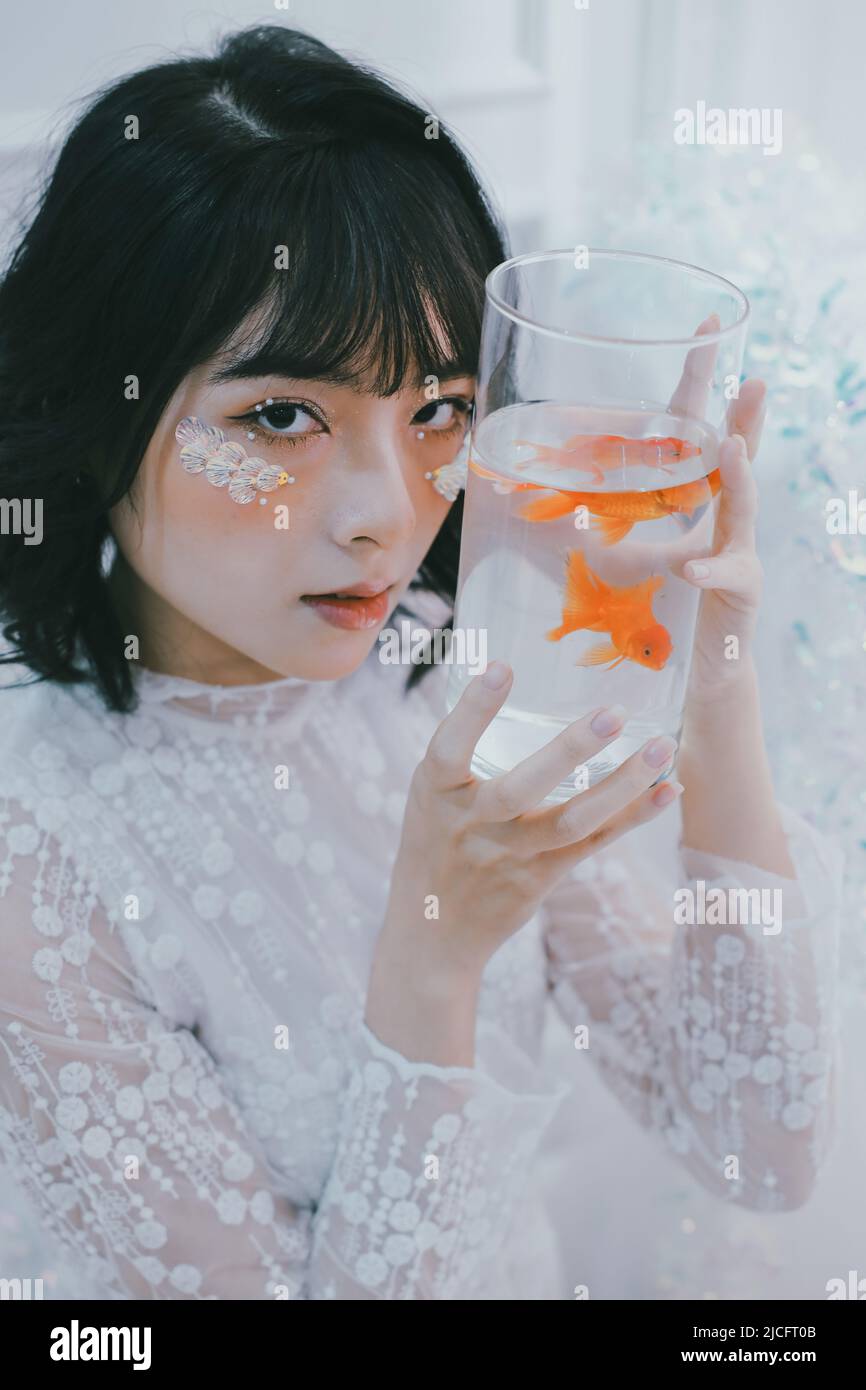 Girl with goldfish hi-res stock photography and images - Alamy