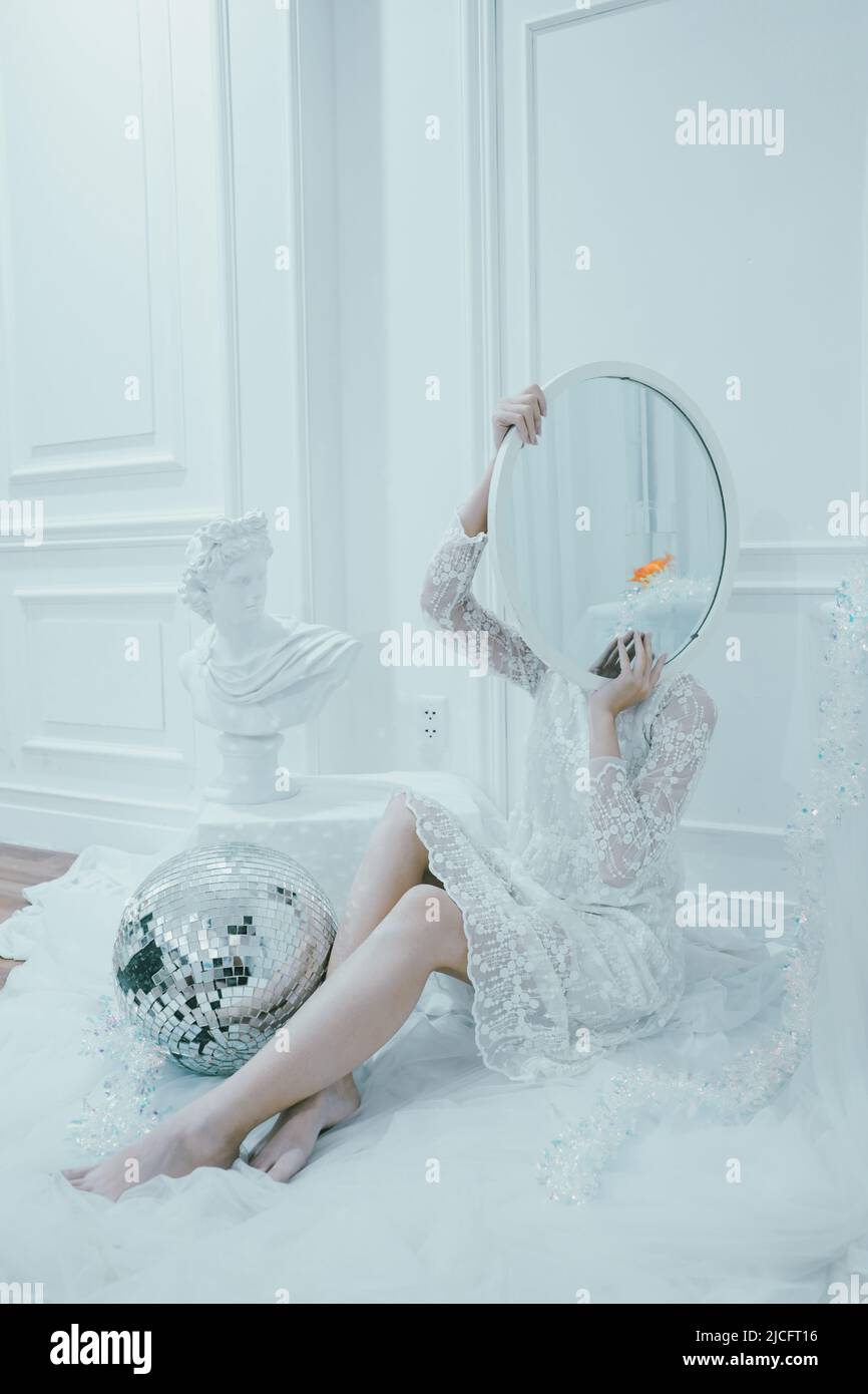 Girl with goldfish in white Stock Photo - Alamy