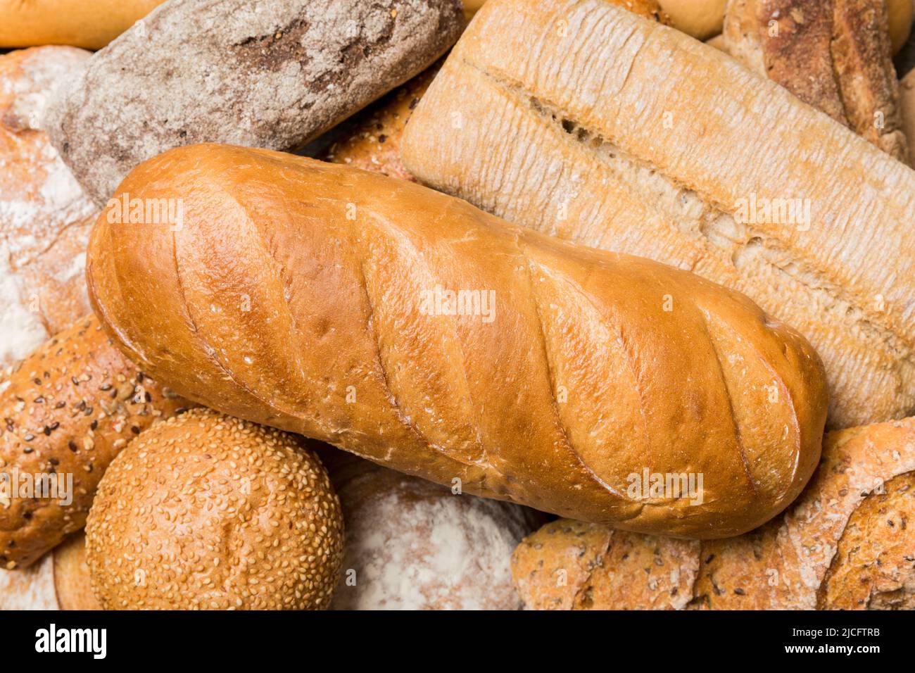 Homemade natural breads. Different kinds of fresh bread as background ...