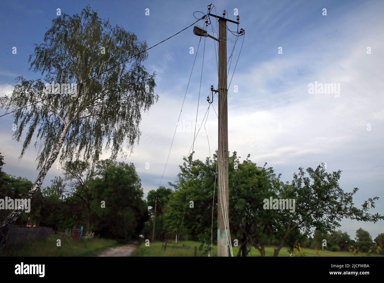 KYIV REGION, UKRAINE - JUNE 4, 2022 - Torn cables hanging on a utility ...
