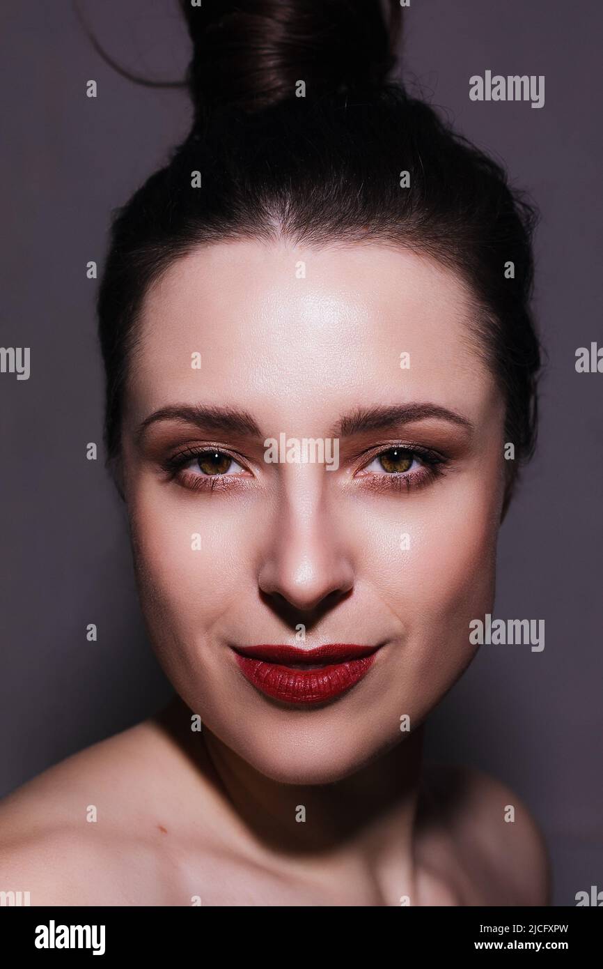 Portrait of a woman wearing elegant bold evening makeup with luxurious ...