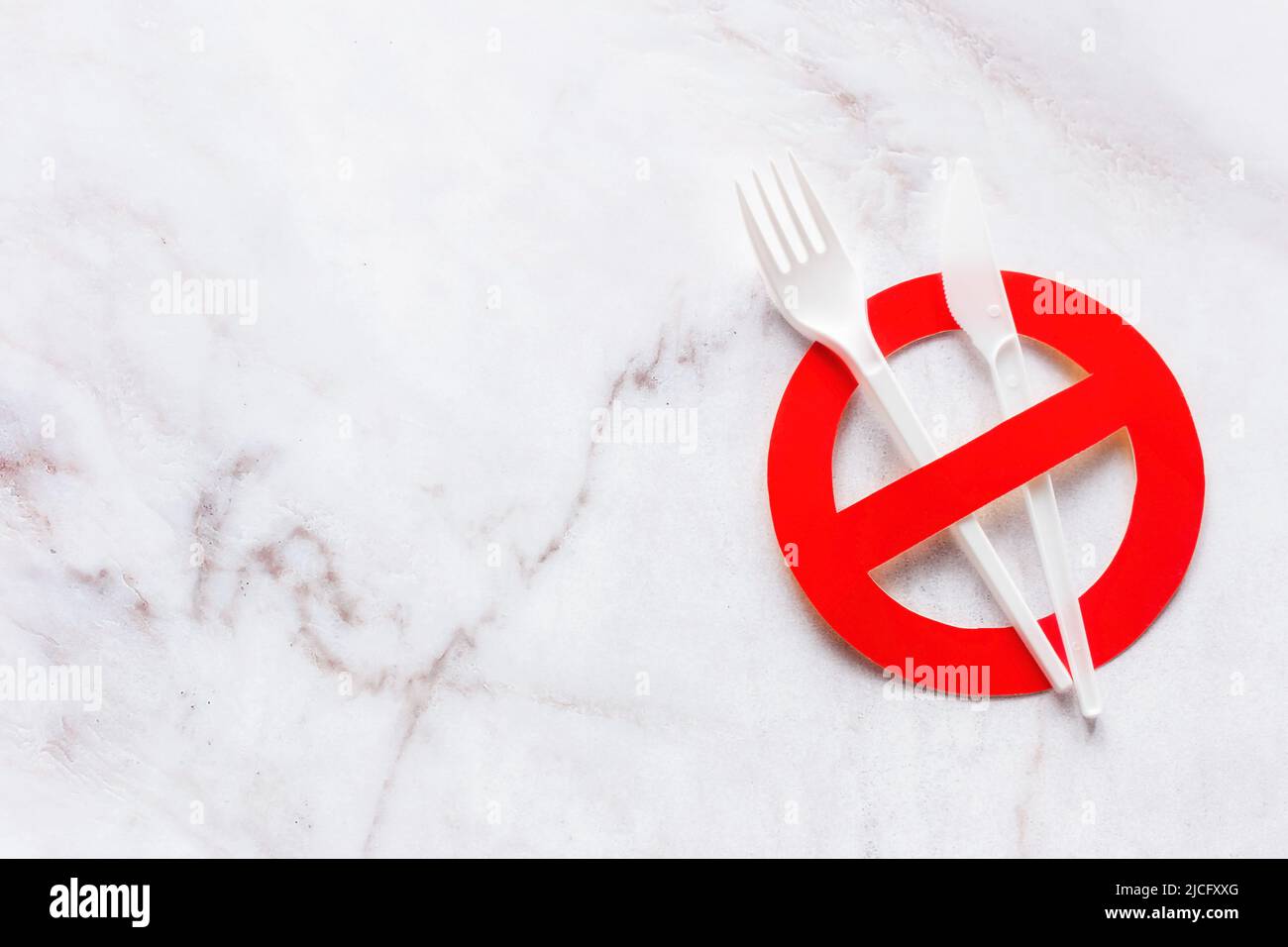 plastic cutlery and prohibition sign with place for text on marble ...