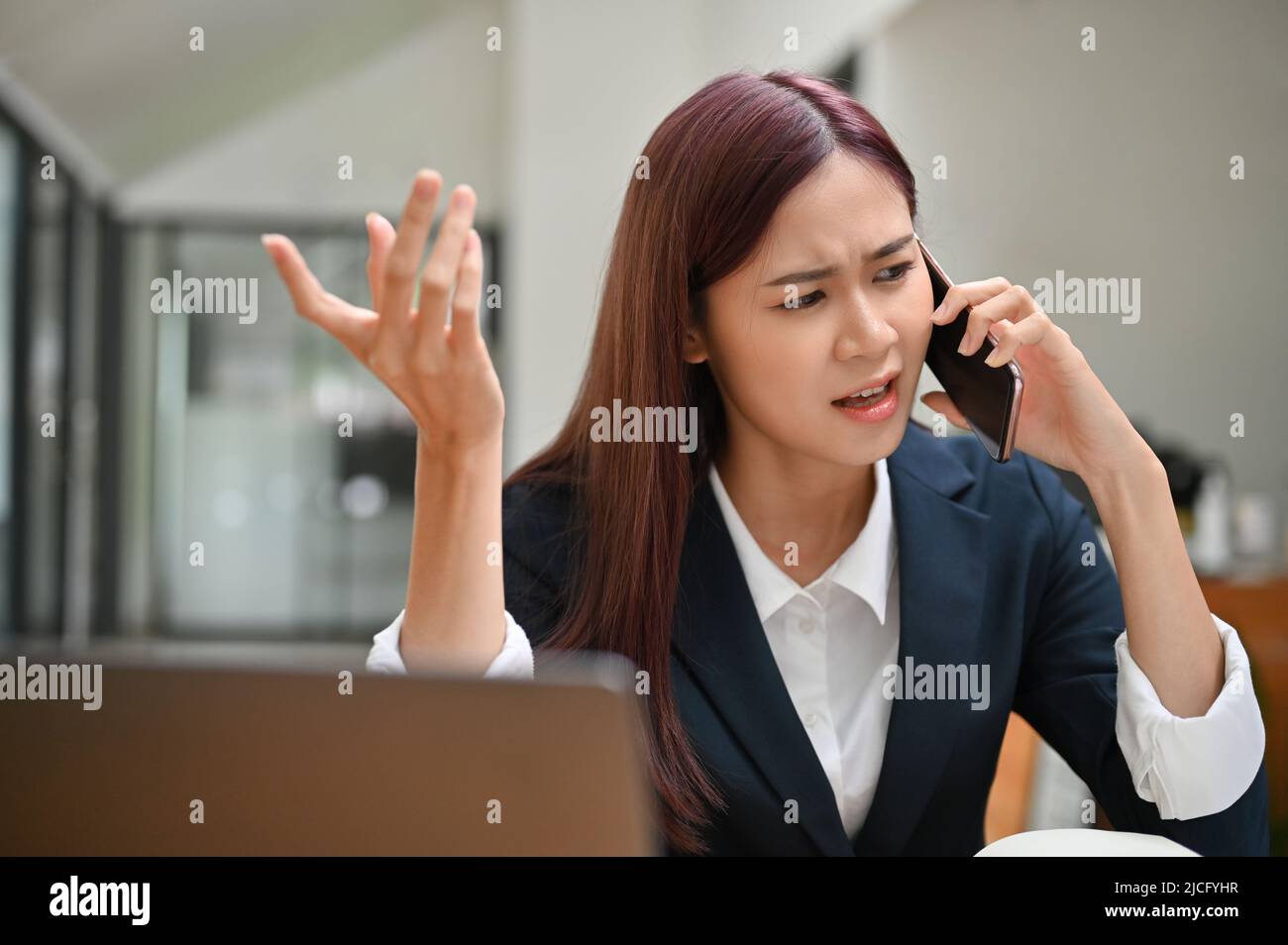 Stressed asian businesswoman or female marketing manager arguing on the ...