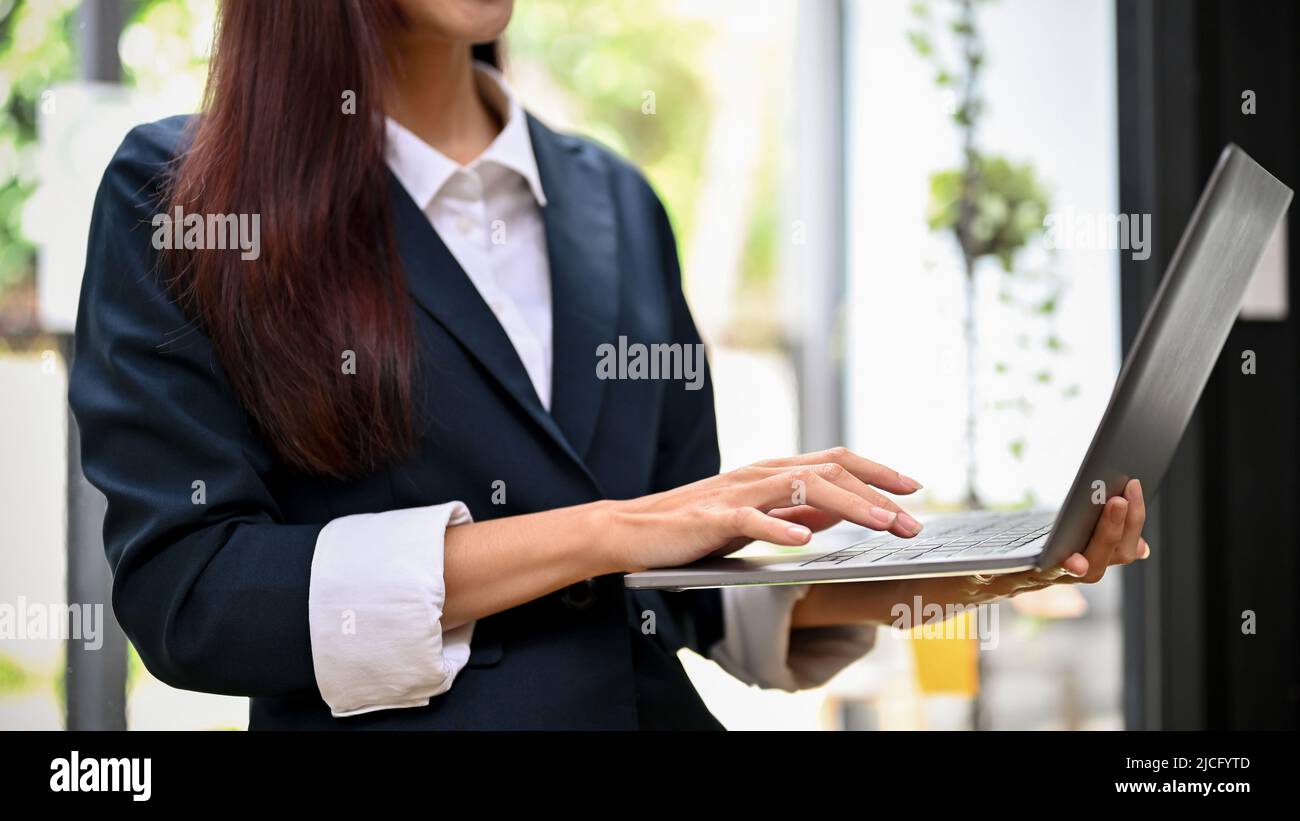 Cropped image, Millennial businesswoman in a formalwear holding a ...