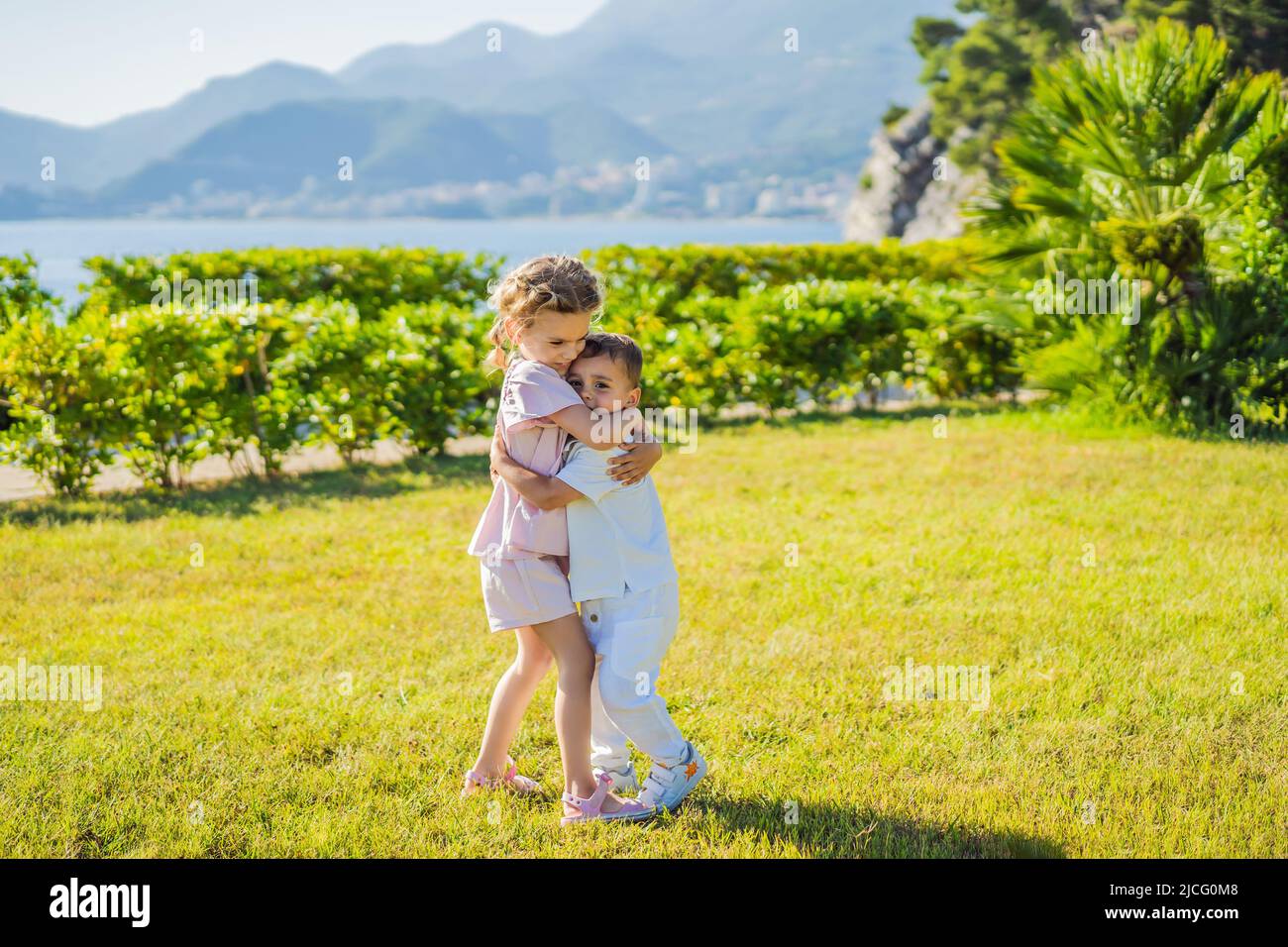 Portrait of two cute adorable baby children toddlers hugging and ...