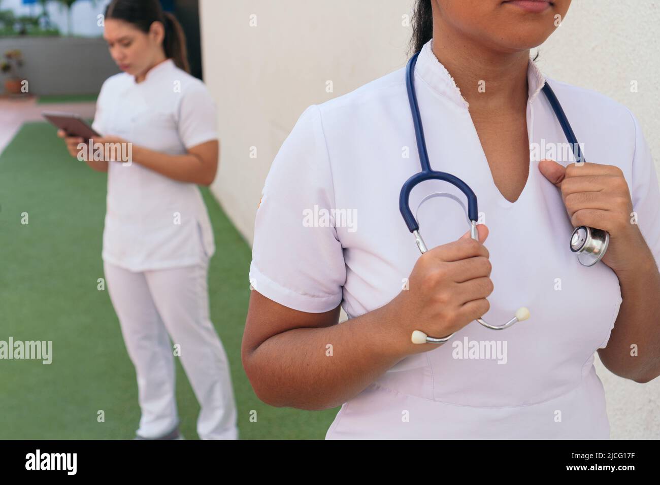 Two doctors walking outside a hospital Stock Photo - Alamy