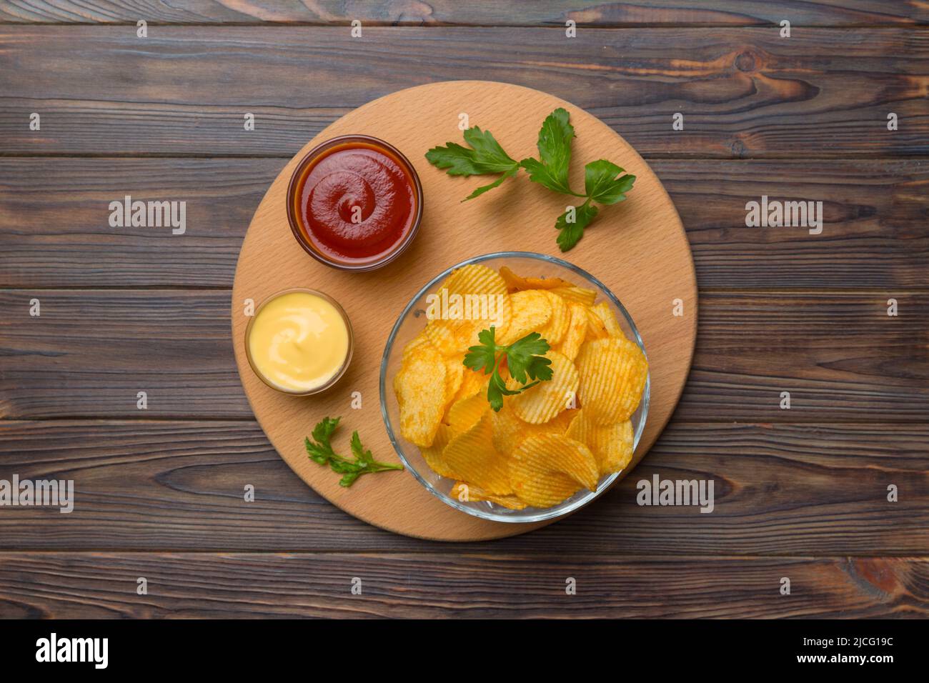 Top view chips with sause in bowl on colored background, top view with ...