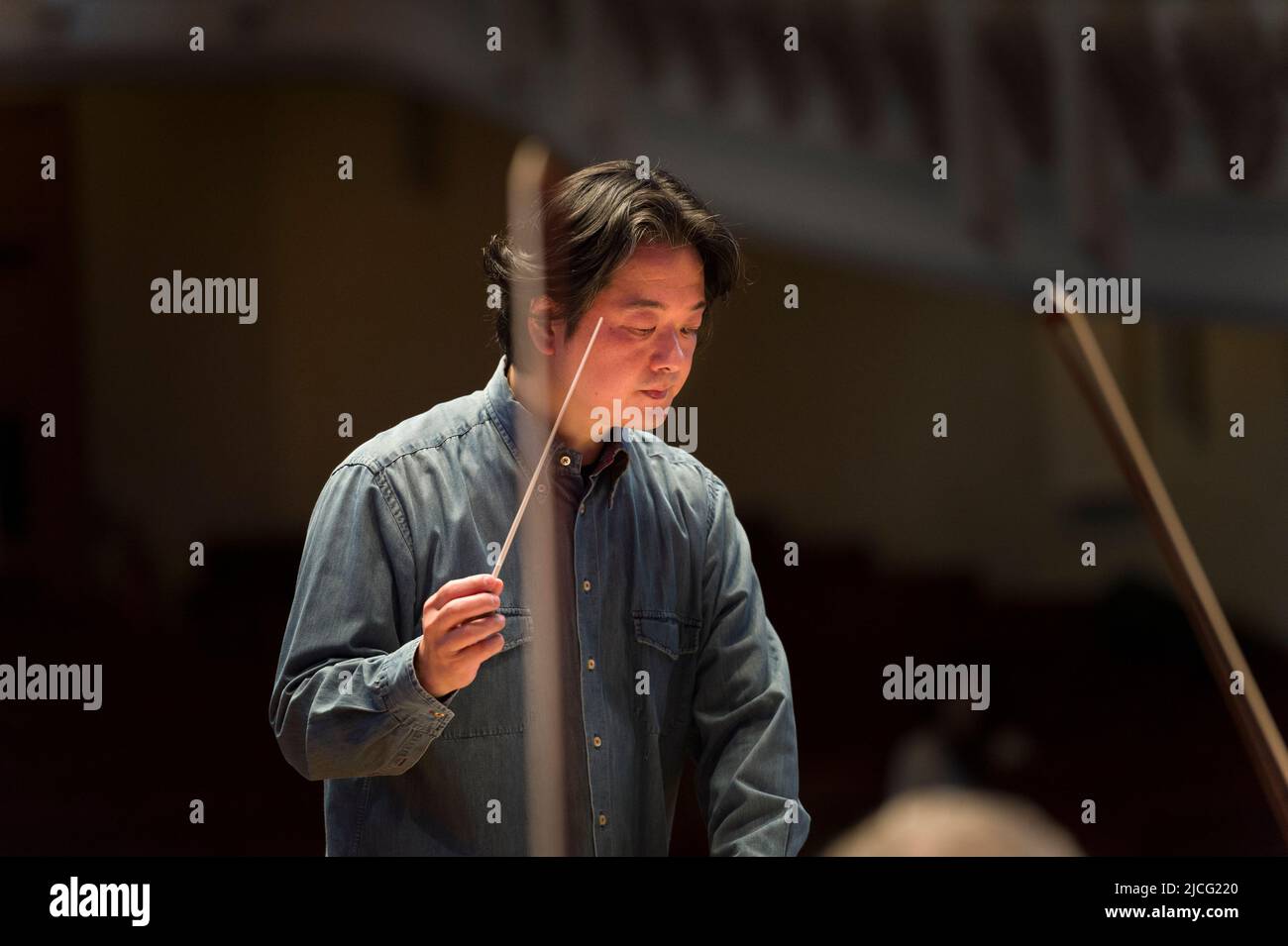 Japanese conductor Daisuke Muranaka conducting a rehearsal of the ...