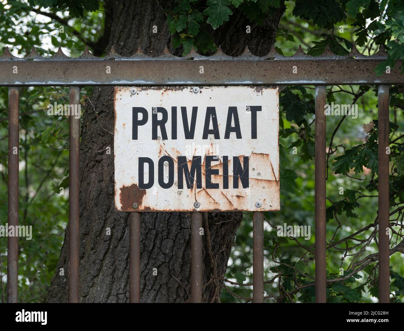 white rusty plaque with black letters on an old fence that says Private ...