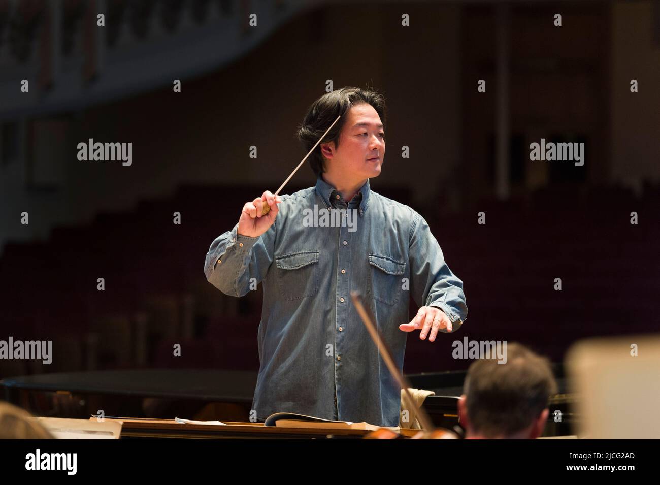 Japanese conductor Daisuke Muranaka conducting a rehearsal of the ...