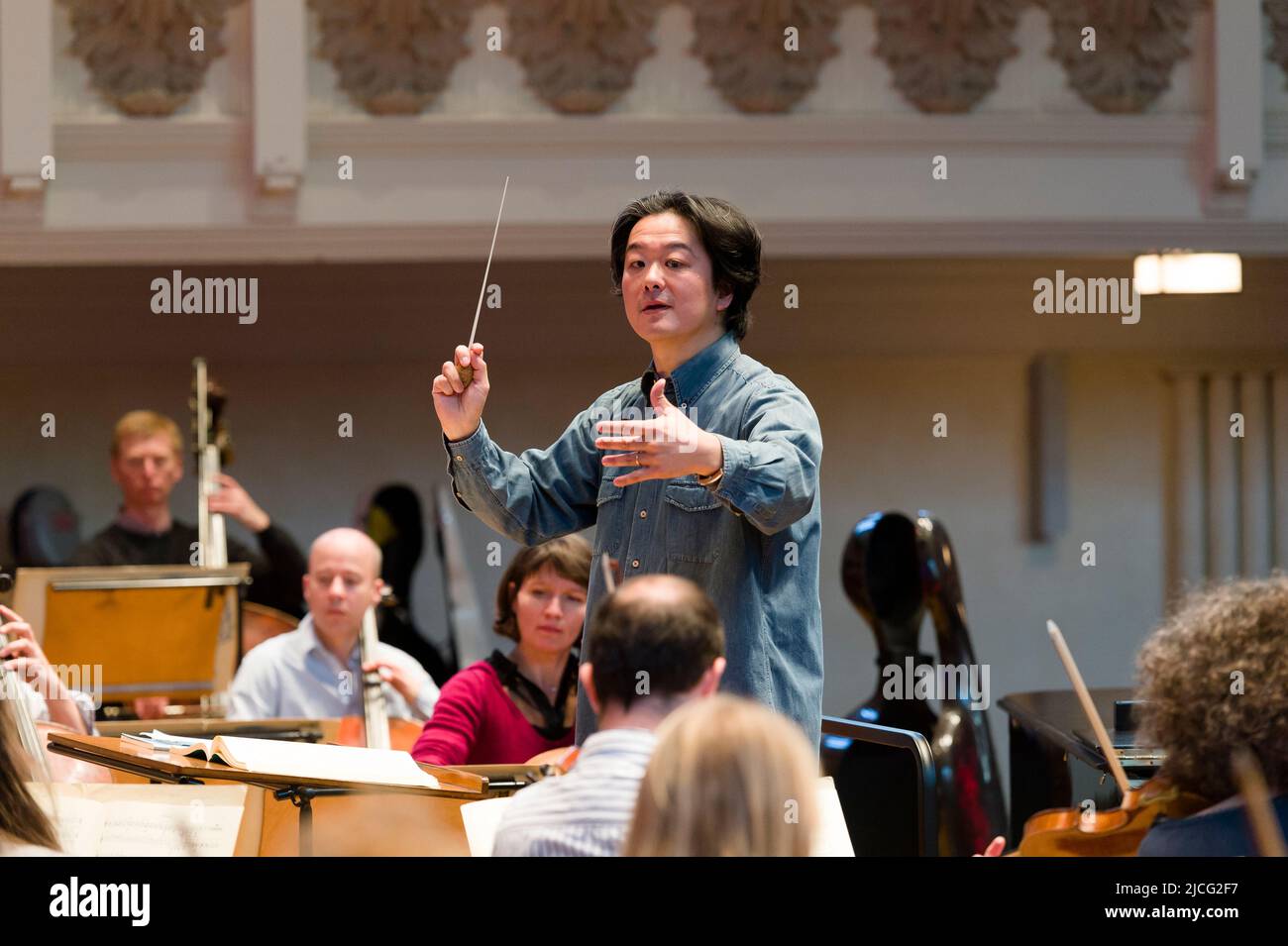 Japanese conductor Daisuke Muranaka conducting a rehearsal of the ...