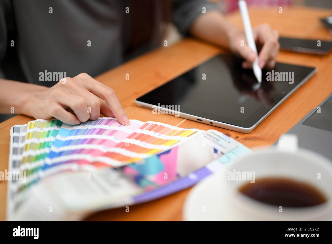 Female graphic designer using digital graphic tablet touchpad with ...