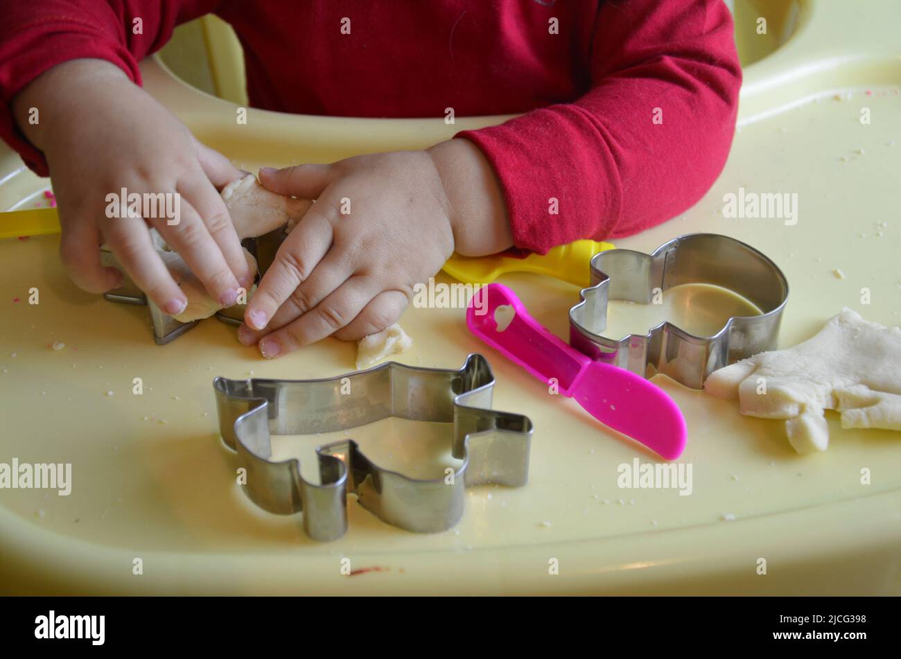 Cute little kid playing with modeling clay at home, workshop, craft and ...