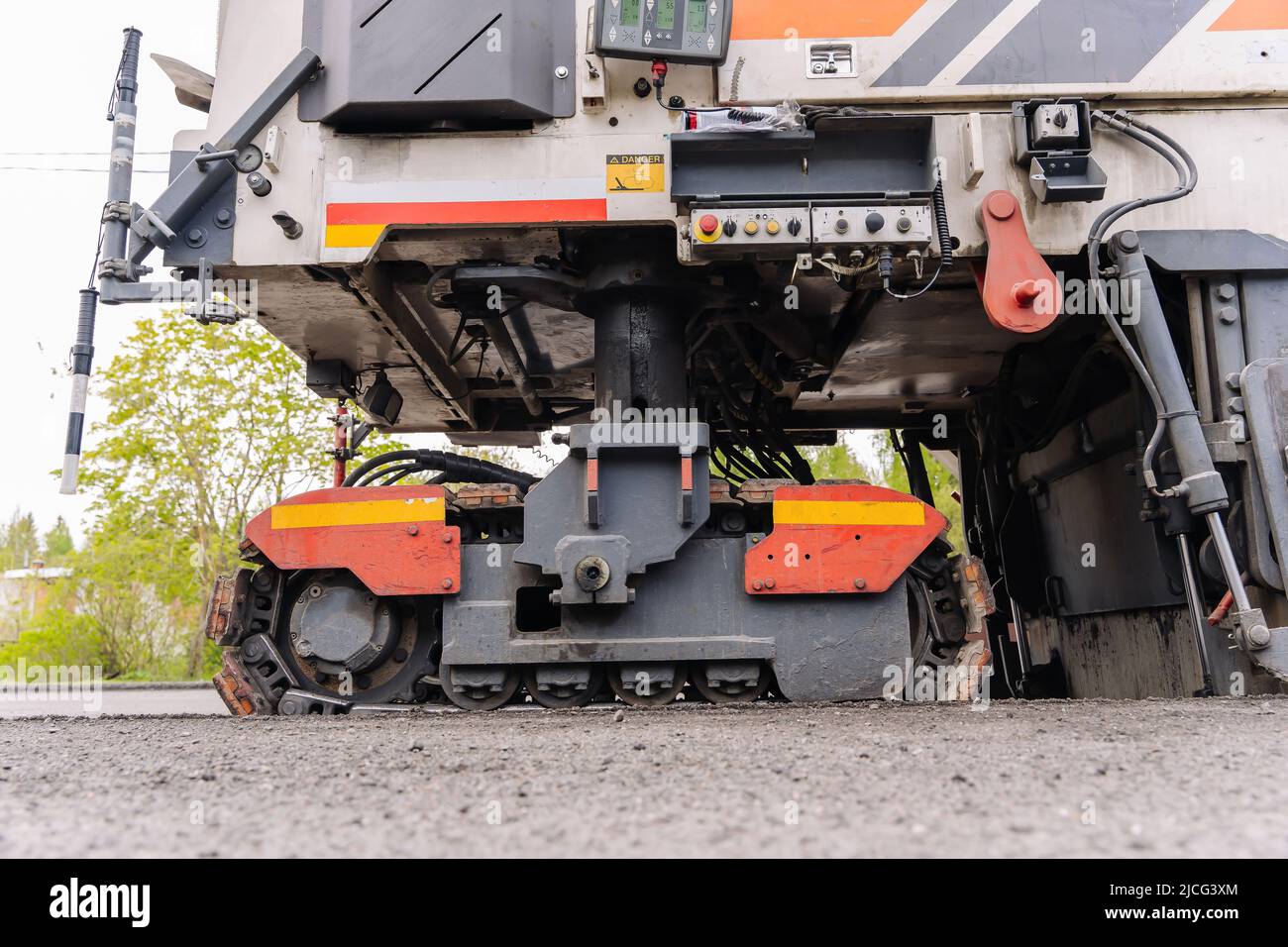 Large Road cold milling machine removes the old asphalt and loading ...