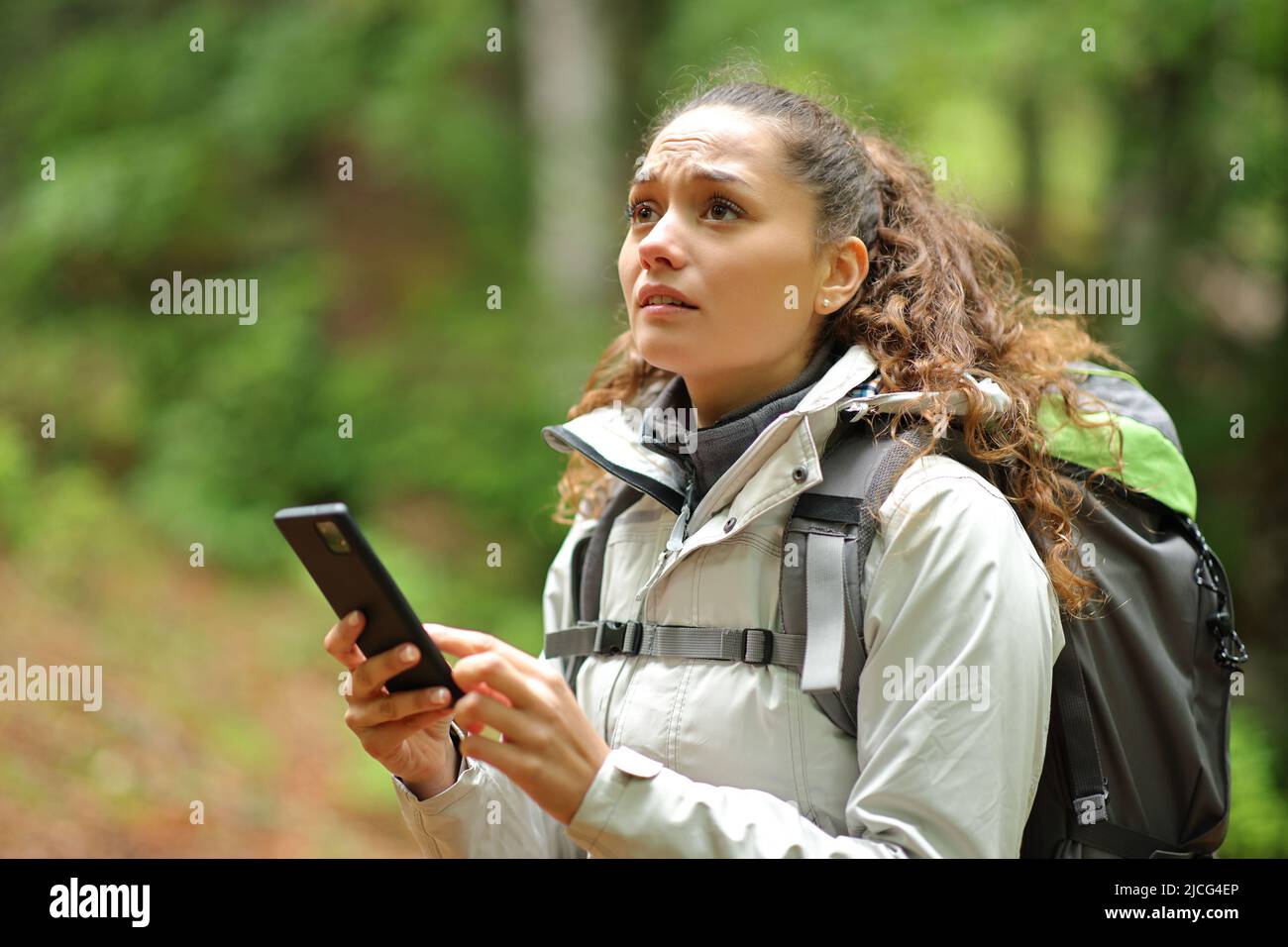 Lost trekker searching location with smart phone alone in a forest ...