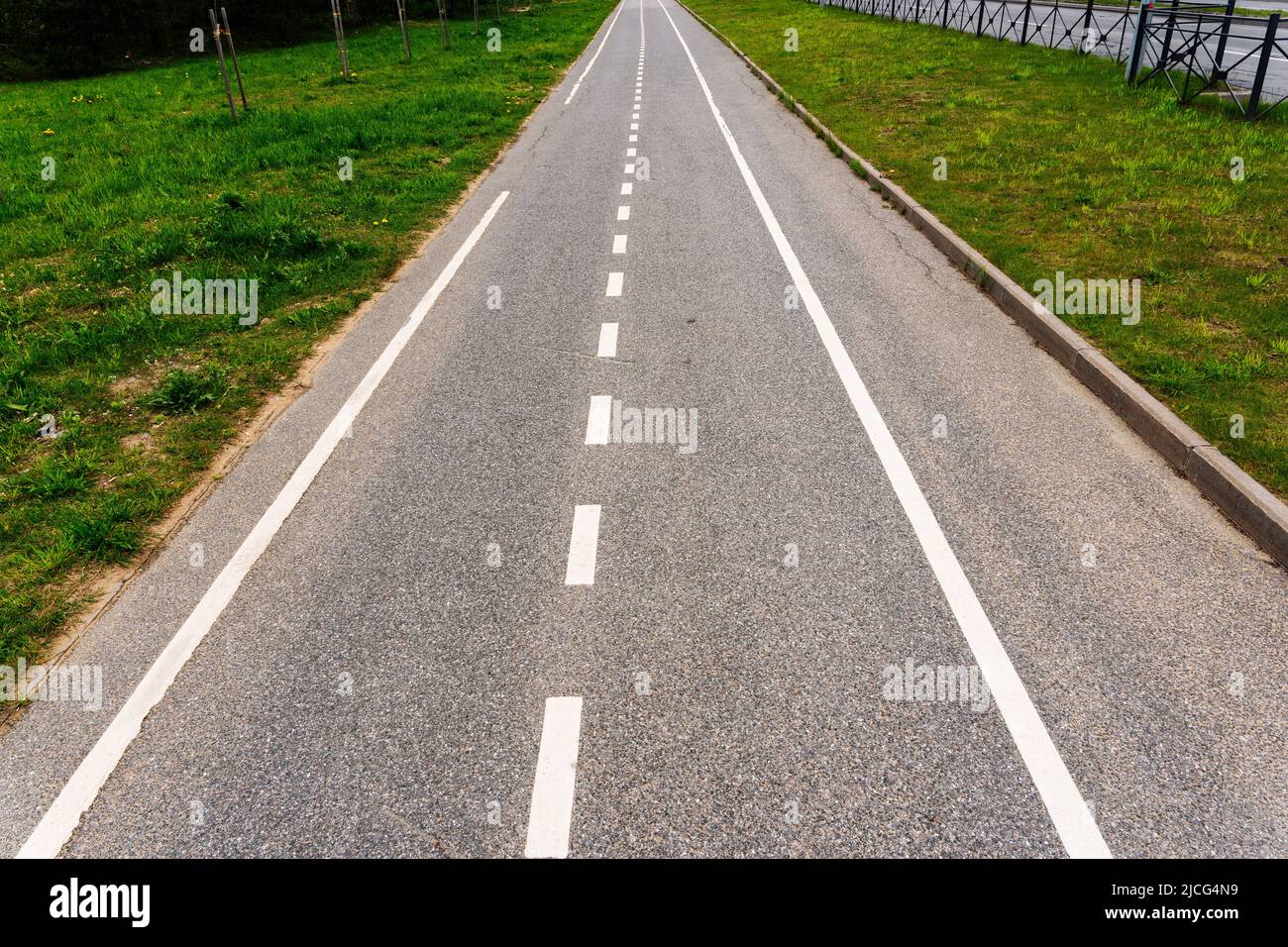 an empty city bike path along a city street in summer Stock Photo - Alamy