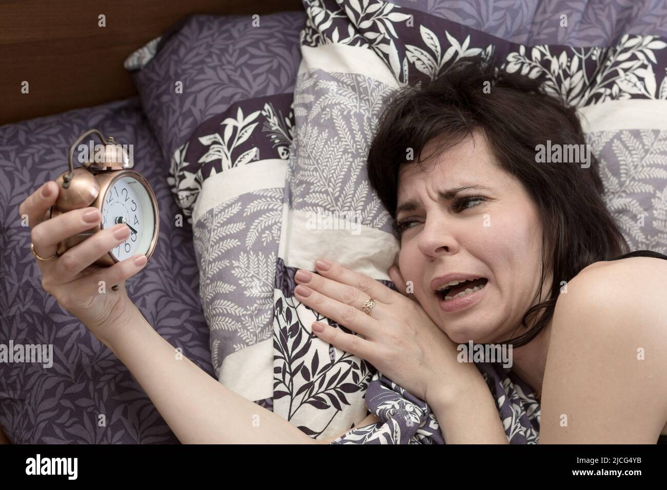 Panic woman jumping out of bed, being late for work Stock Photo - Alamy