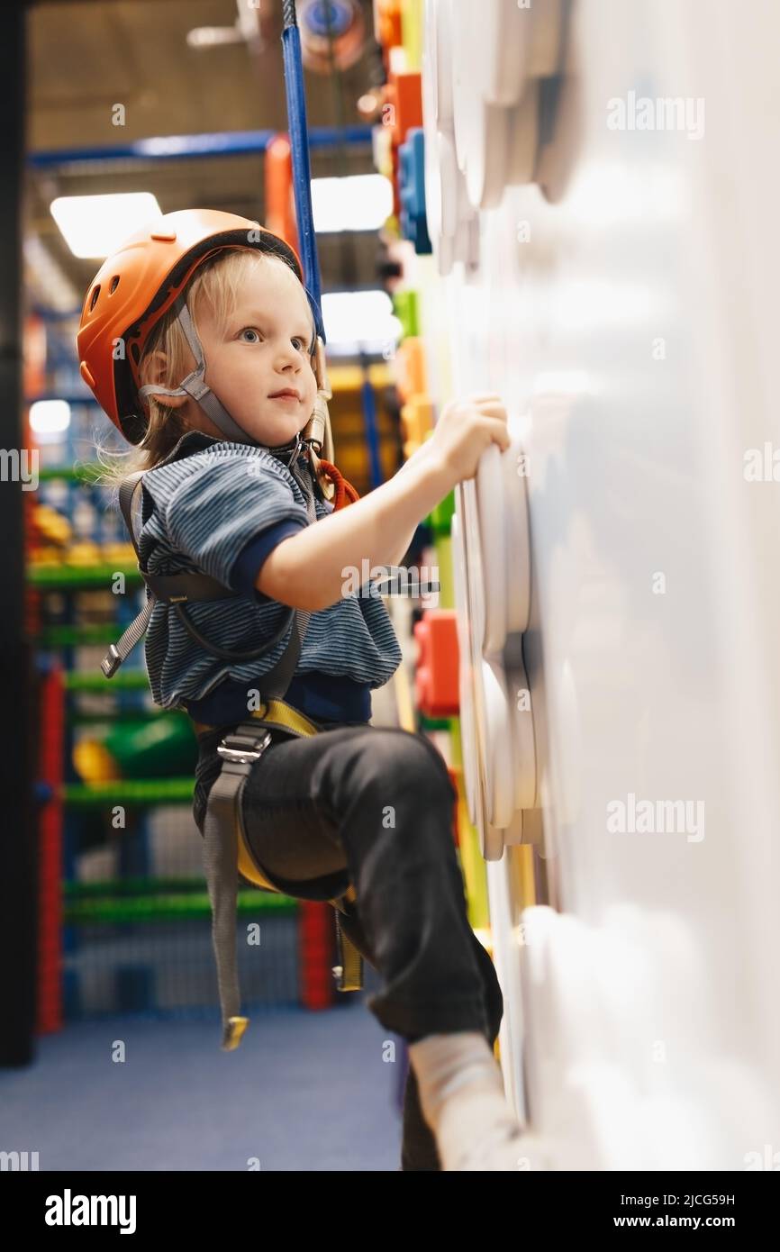 Happy Child in Red Helmet on Climbing Class at Indoor Climbing and ...