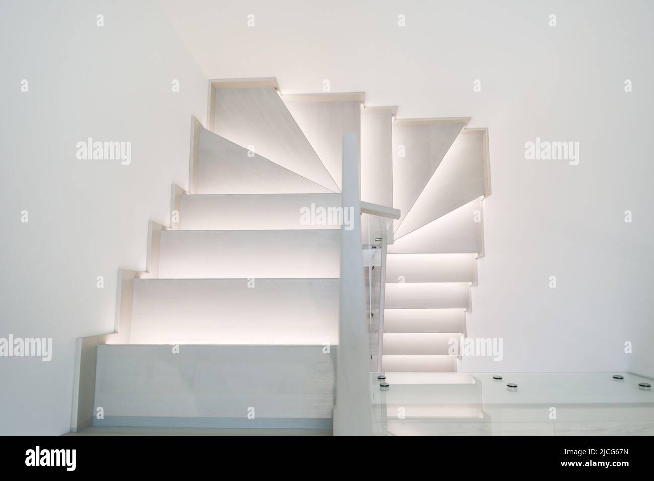 Illuminated wooden staircase in duplex apartment Stock Photo - Alamy