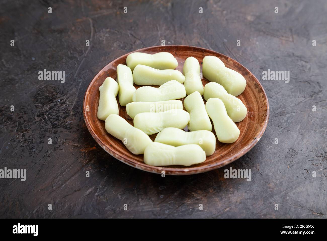 Jelly celery candies on black concrete background, side view, close up ...