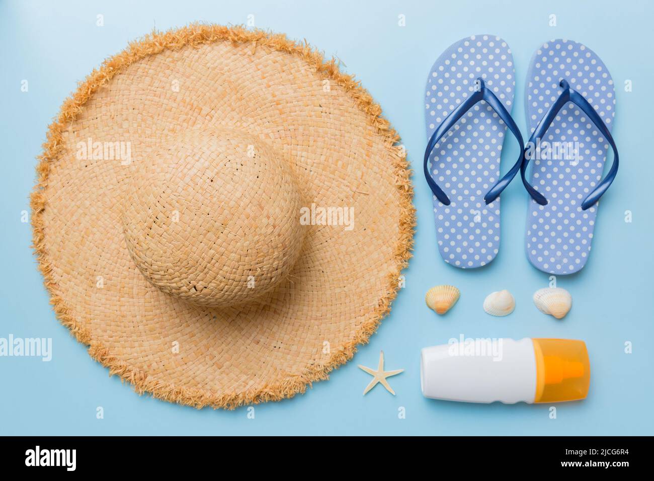 Summer vacation concept flat lay. straw hat beach accessories and towel ...