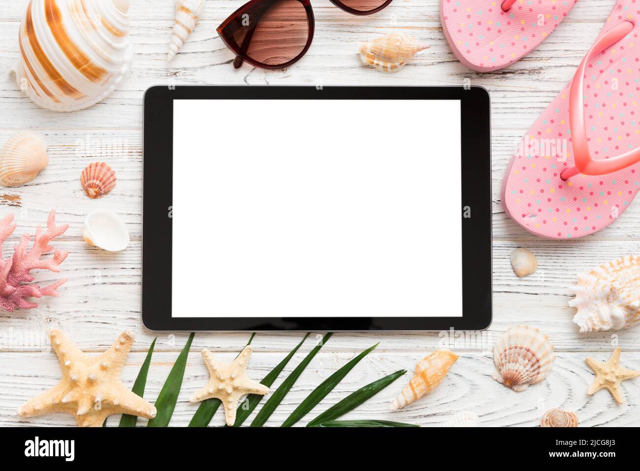 Flat lay composition with tablet and beach accessories on colored ...