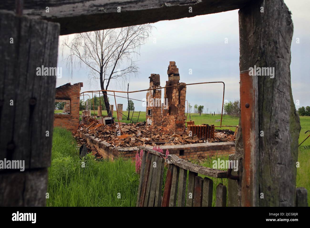 Kiev Region, Ukraine - June 4, 2022 - Chimneys remain standing among ...
