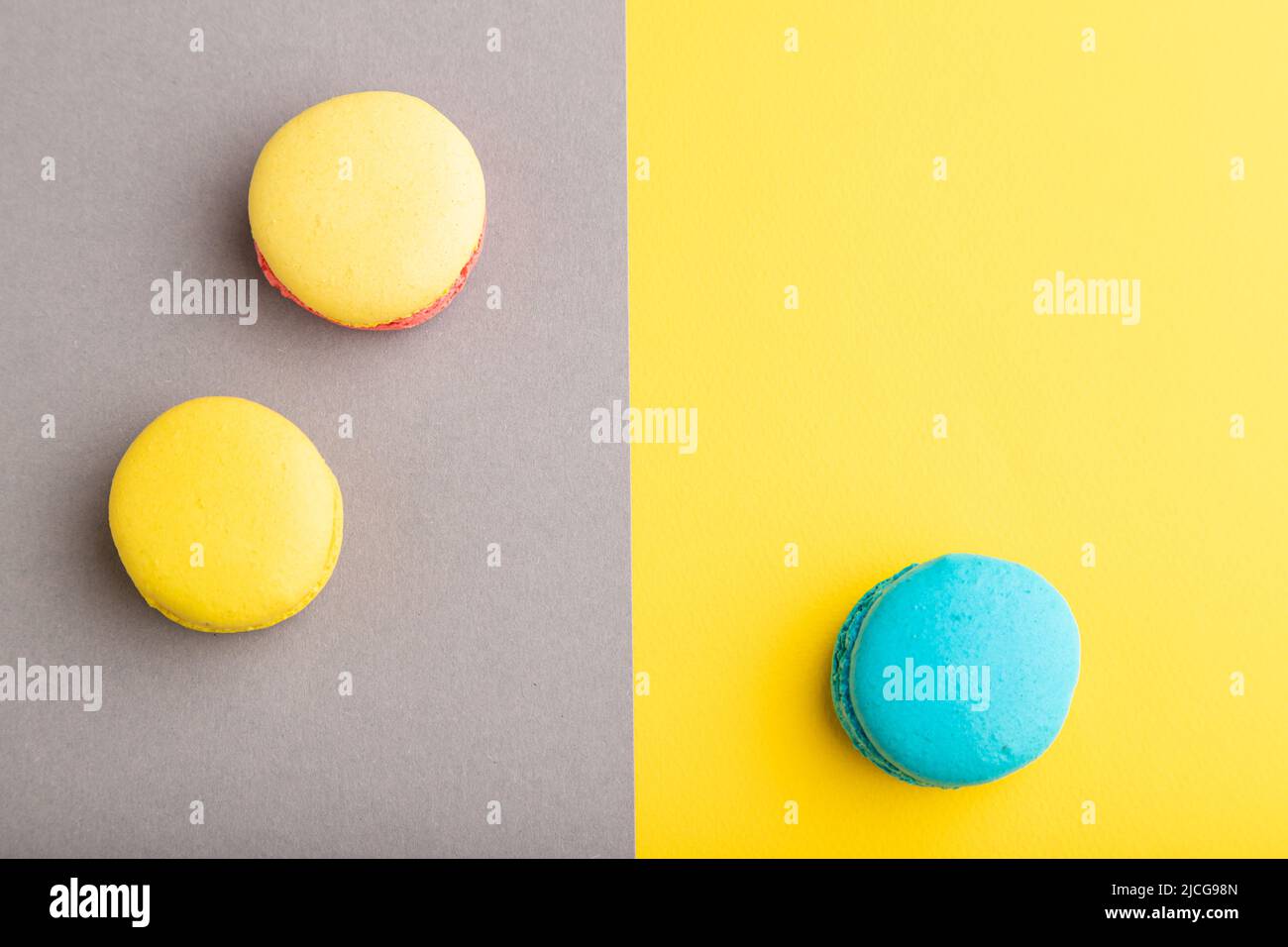 Yellow and blue macaroons on trendy gray and yellow background. top ...