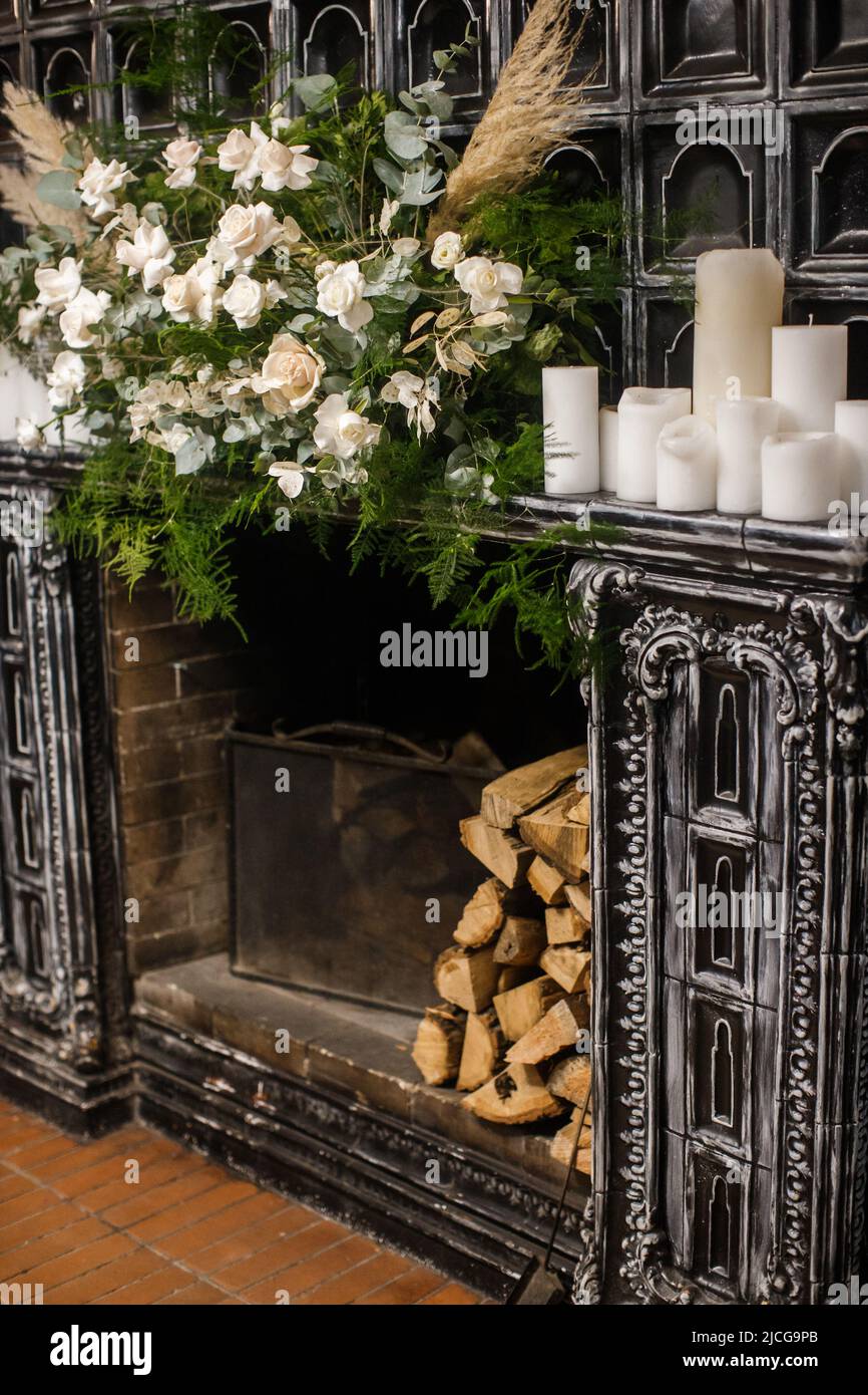 Fireplace decorated with a bouquet of flowers and candles Stock Photo ...