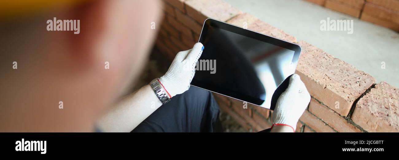 Construction worker holding tablet with black turned off screen Stock ...
