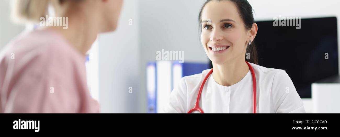Smiling doctor measuring patients blood pressure with tonometer tool ...