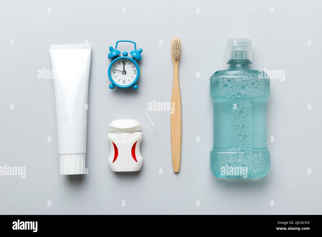 Mouthwash and other oral hygiene products on colored table top view ...