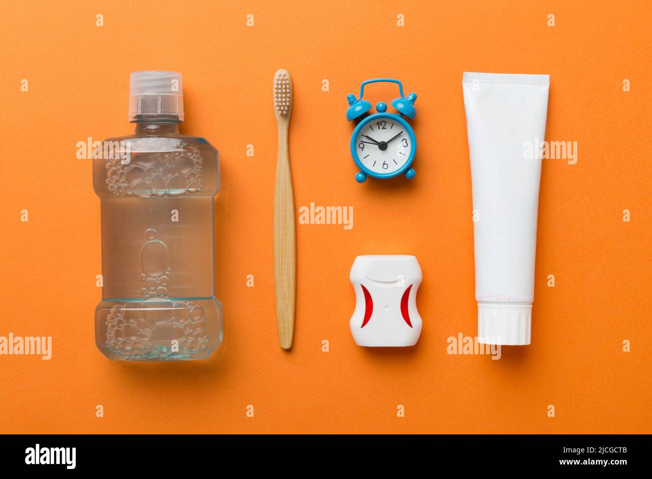 Mouthwash and other oral hygiene products on colored table top view ...