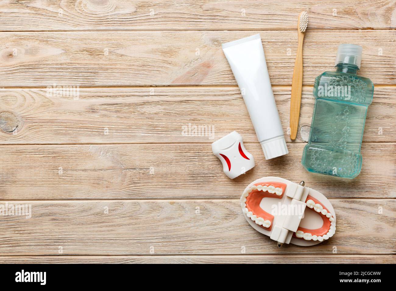 Mouthwash and other oral hygiene products on colored table top view ...