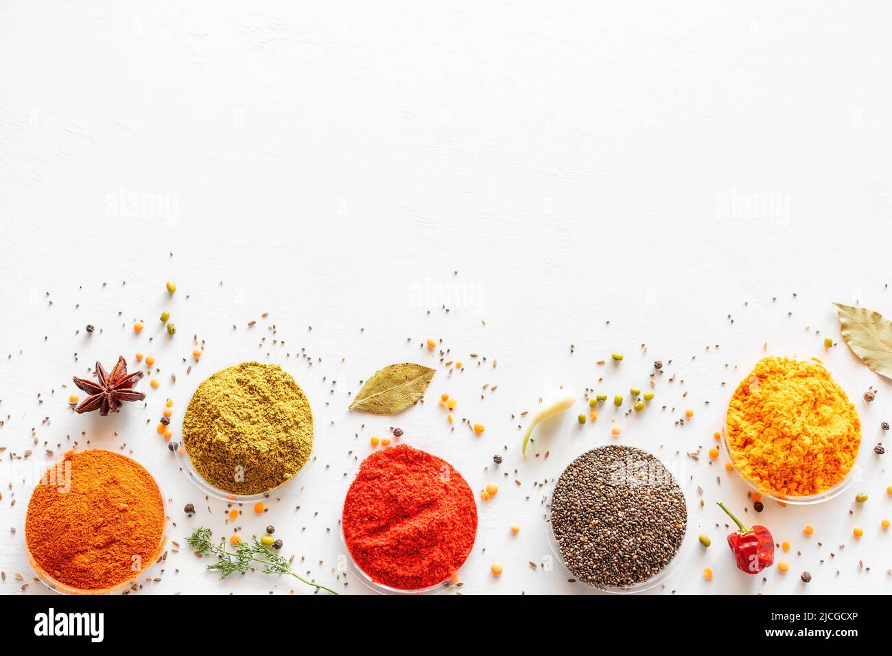 colorful spices and seasonings on a white background Stock Photo - Alamy
