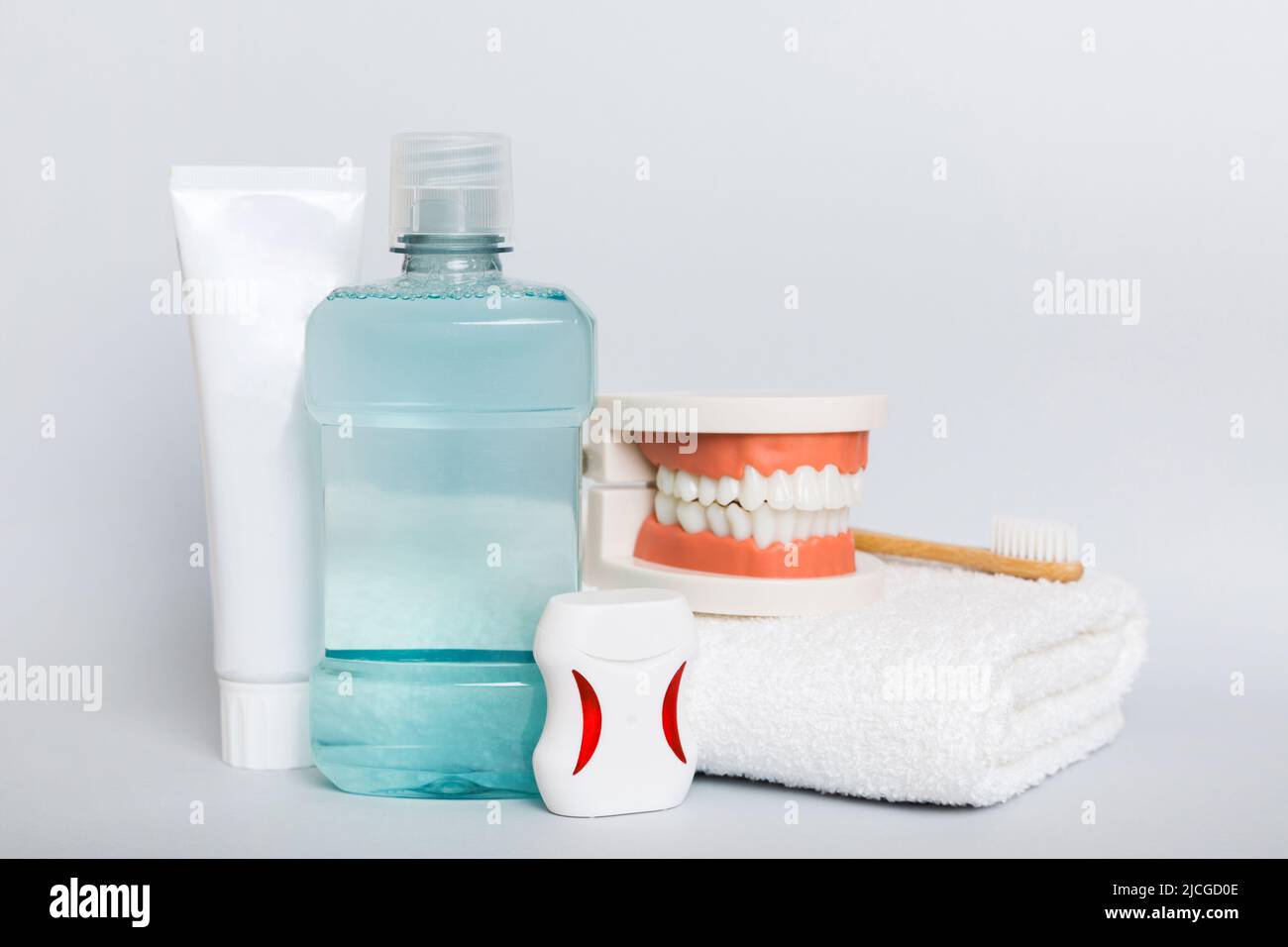 Mouthwash and other oral hygiene products on colored table top view ...