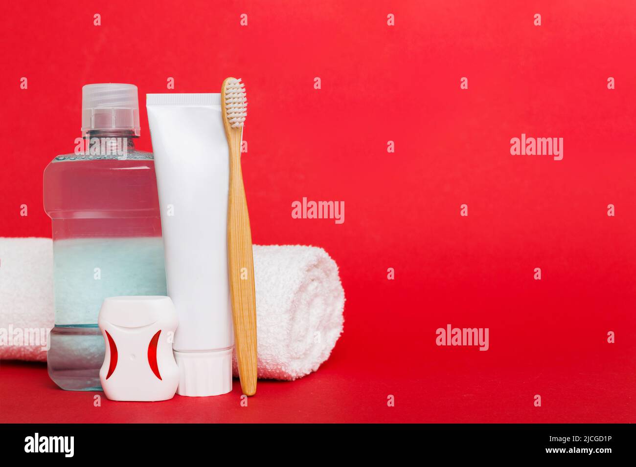 Mouthwash and other oral hygiene products on colored table top view ...