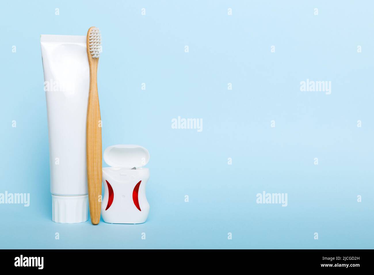 toothpaste and toothbrush top view with copy space on colored ...