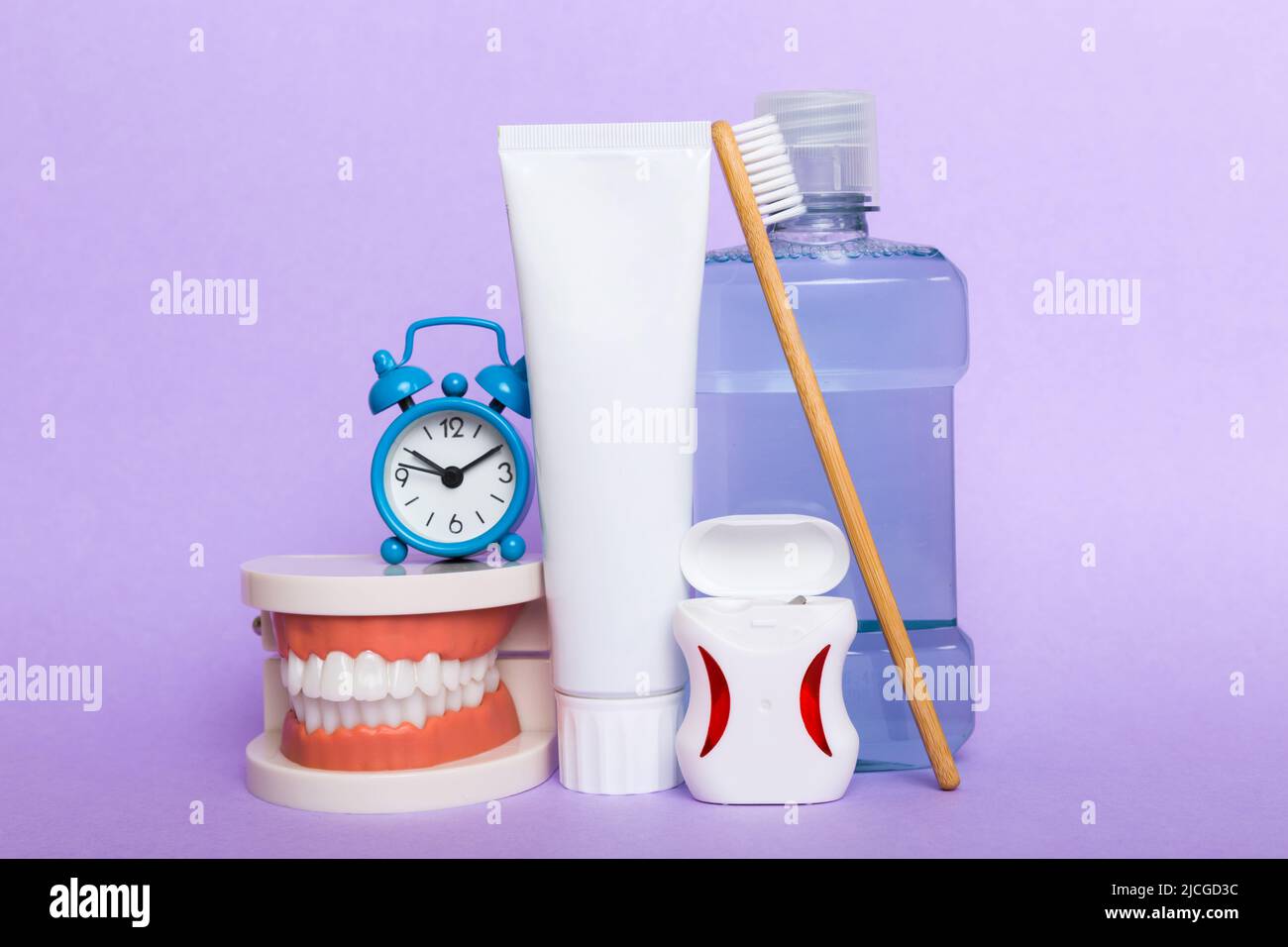 Mouthwash and other oral hygiene products on colored table top view ...