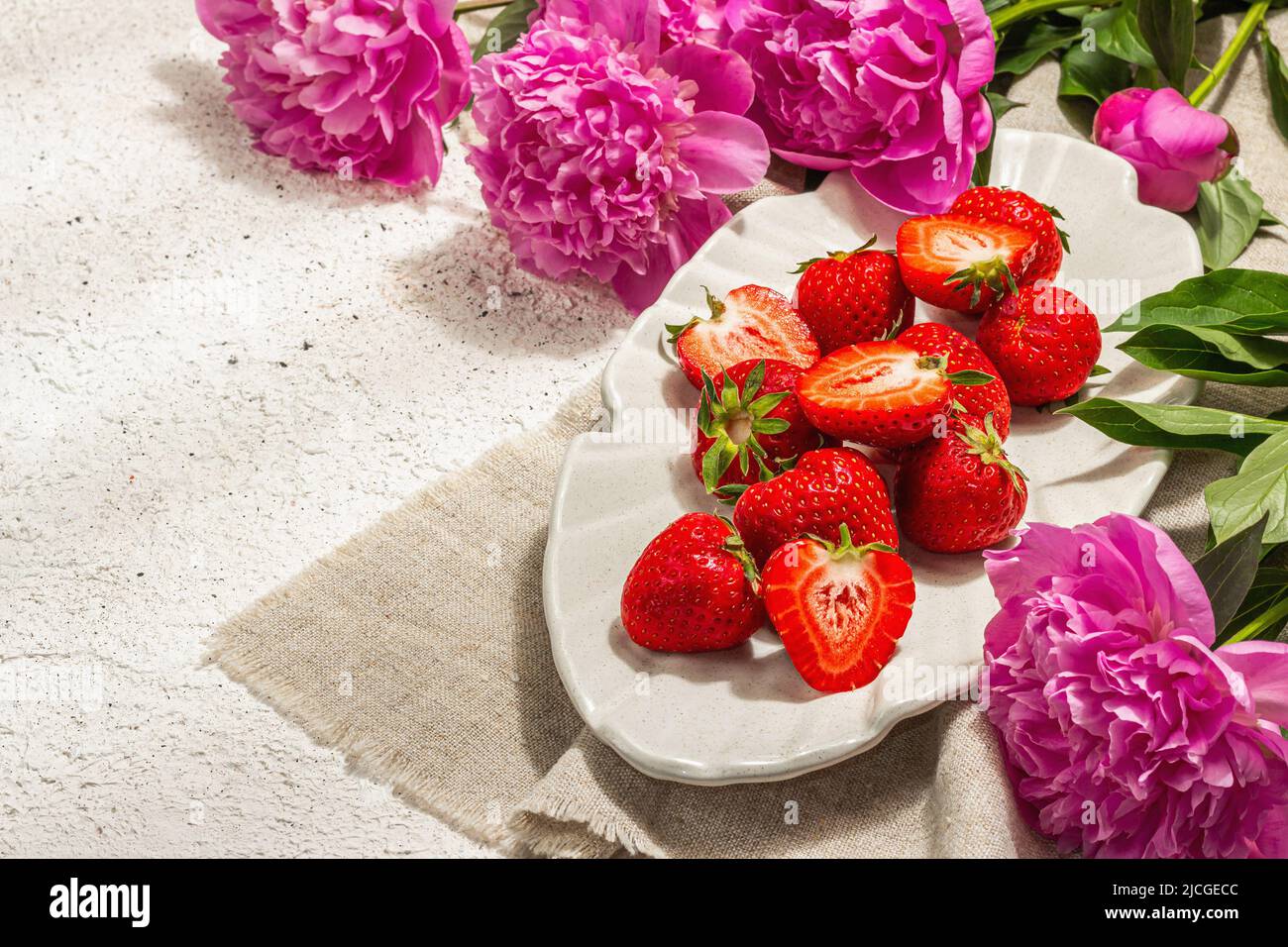 Sweet ripe strawberries and fragrant peonies bouquet. Summer plaster ...